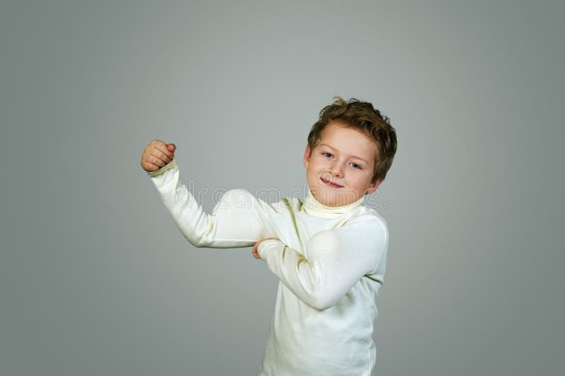 The boy shows his strength stock image. Image of biceps - 84635961