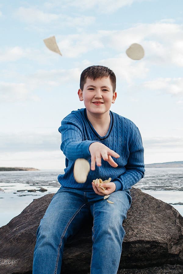 The Boy Sits on the Rocks by the River Stock Image - Image of blue ...