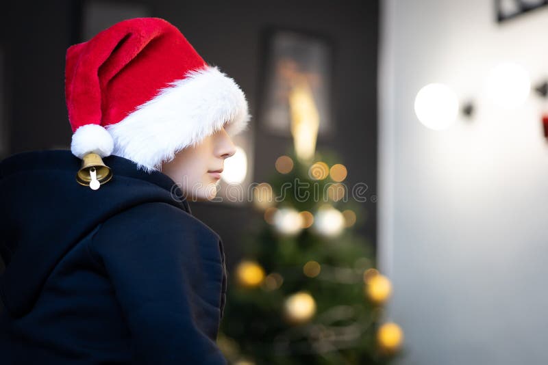 The Boy Sits Sideways on the Sofa in the Studio and Looks at the ...