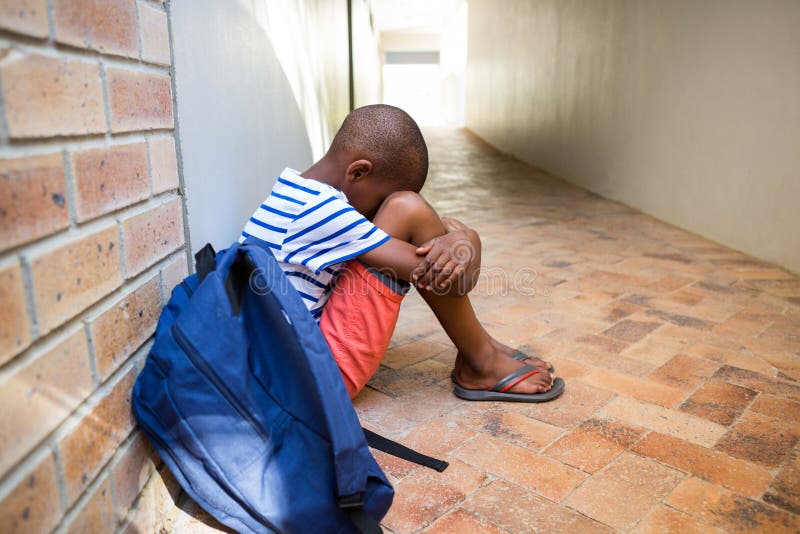 Boy Sitting Alone on School Corridor Stock Photo - Image of school ...