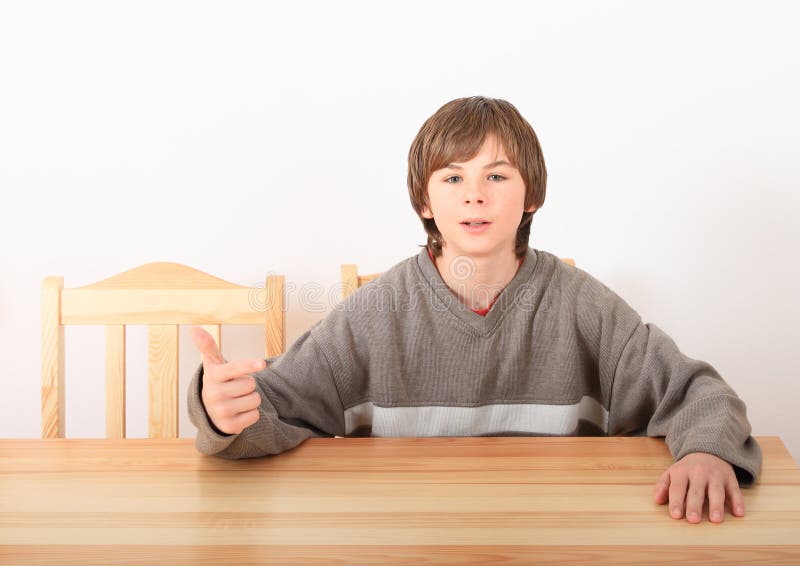 Boy Sitting Behind Wooden Table Stock Photo - Image of table ... Boy Sitting Behind Wooden Table Stock Photo - Image of table ...
