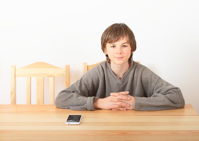 Boy Sitting Behind Wooden Table Stock Photo - Image of telephone ... Boy Sitting Behind Wooden Table Stock Photo - Image of telephone ...