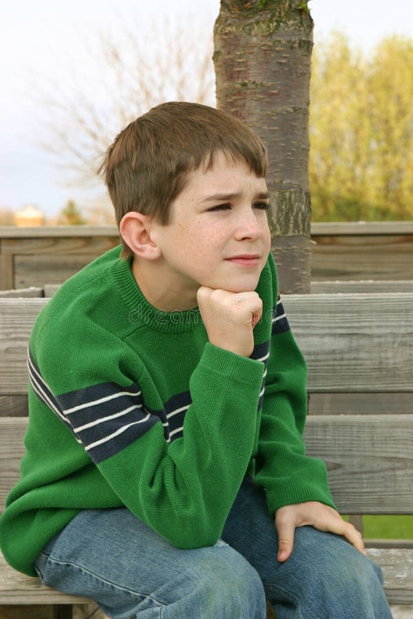 Boy Sitting on Bench stock photo. Image of handsome, close - 2248730