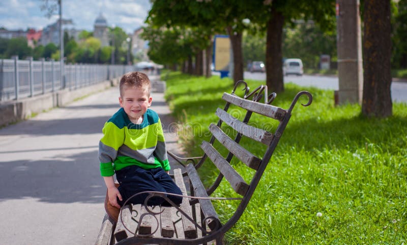Boy sitting on bench stock image. Image of bench, sitting - 110736985