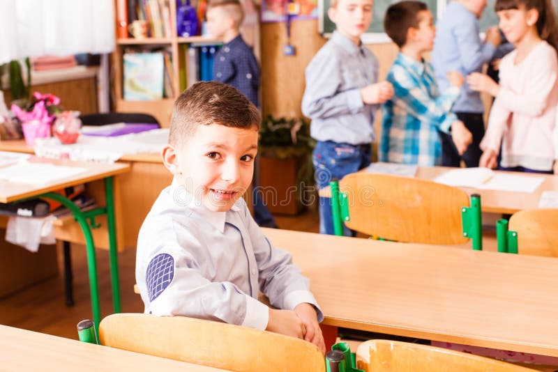 Cute Boy is Sitting at the Desk in the Classrom Stock Image - Image of ...