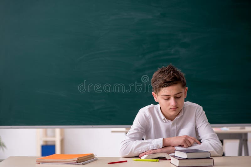 Boy Sitting in the Classrom Stock Image - Image of studying, books ...
