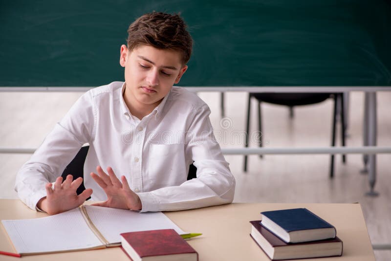 Boy Sitting in the Classrom Stock Photo - Image of college, classroom ...
