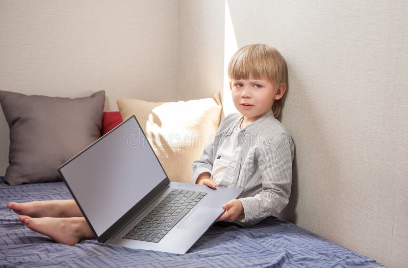 Boy is Sitting on the Couch with a Laptop and Crying because it is ...