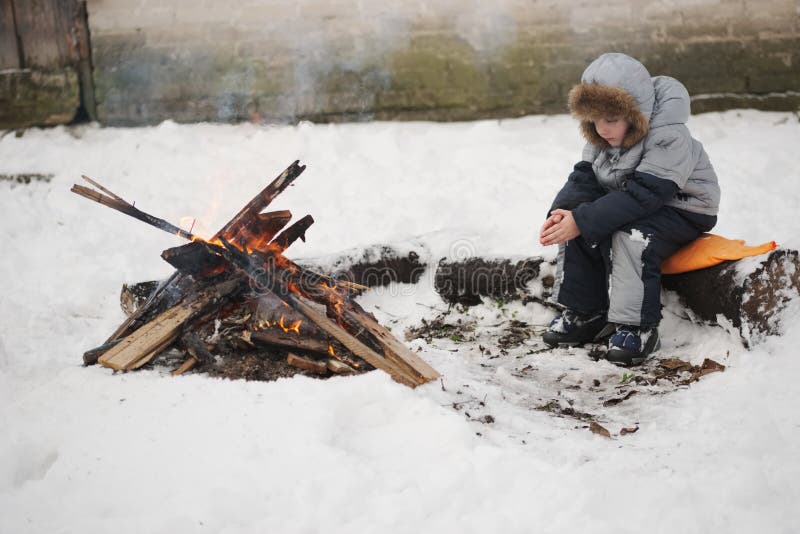 Boy Sitting by Fire in the Street Stock Photo - Image of landscape ...