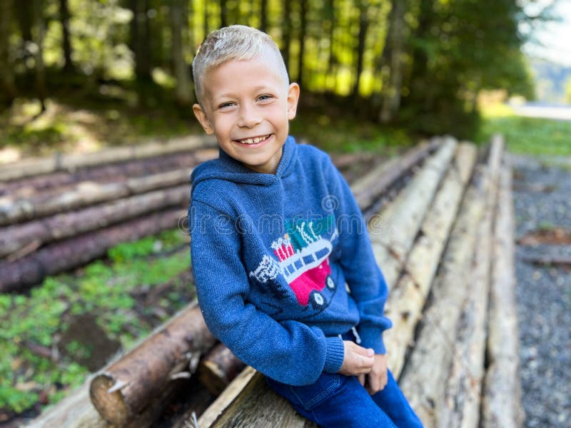 Boy Sitting in Forests stock photo. Image of holiday - 263569836