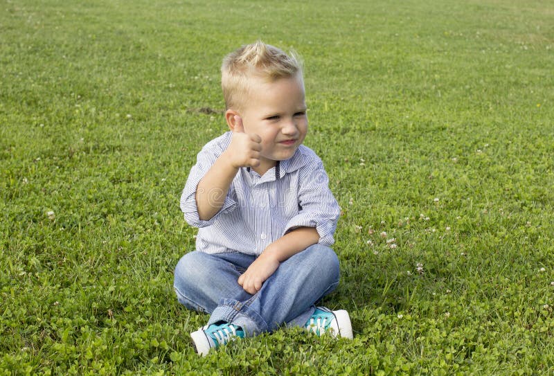 Boy sitting on the grass stock photo. Image of baby, lying - 35967816