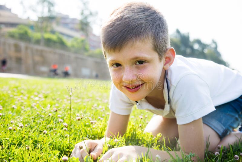 Boy sitting grass stock photo. Image of contemplation - 128563600