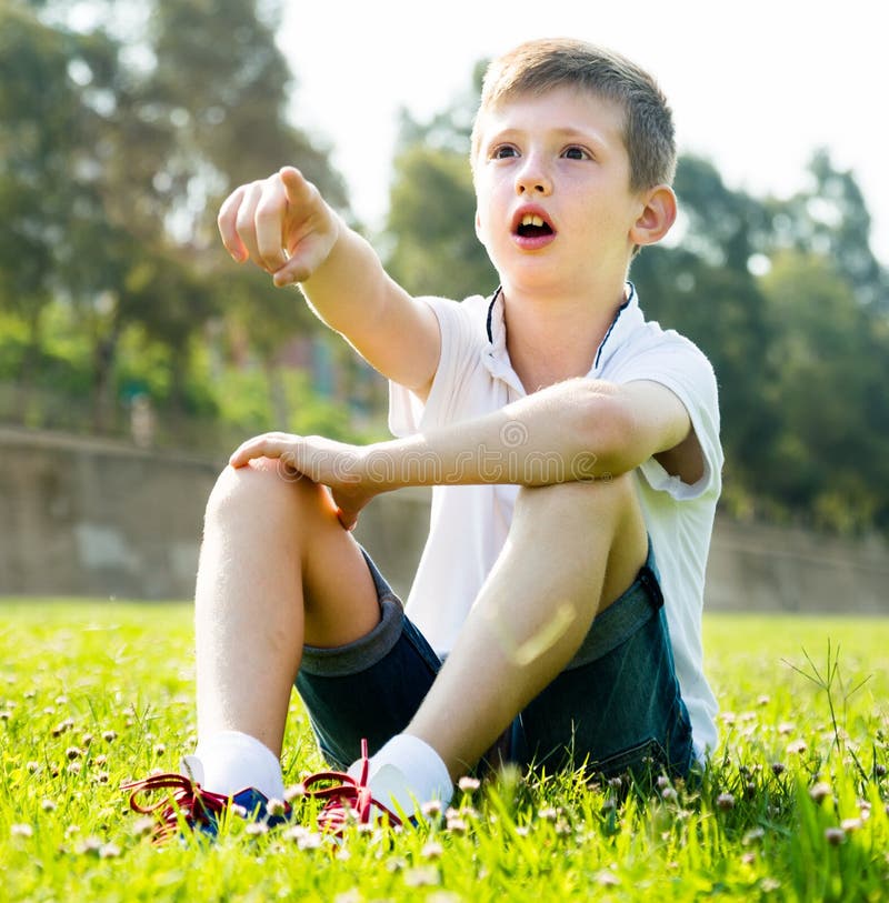 Boy sitting grass stock photo. Image of happiness, childhood - 110758072