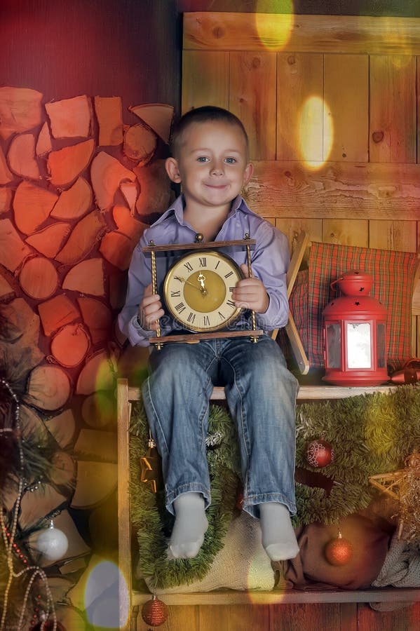 Boy Sitting Holding Clocks in the Hands of a Waiting Midnight Stock ...