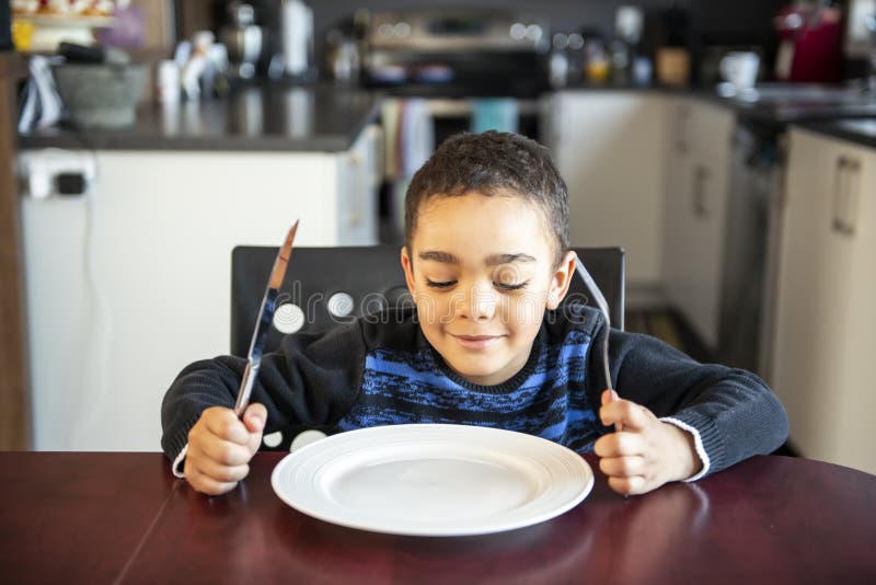 Boy Sitting at the Kitchen Table with Empty Plate Stock Photo - Image ...