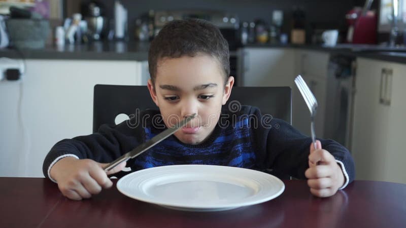 Boy Sitting at the Kitchen Table with Empty Plate Stock Footage - Video ...
