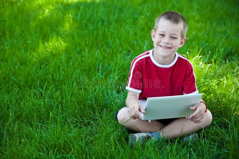Boy Sitting with a Laptop on the Grass Stock Image - Image of white ...