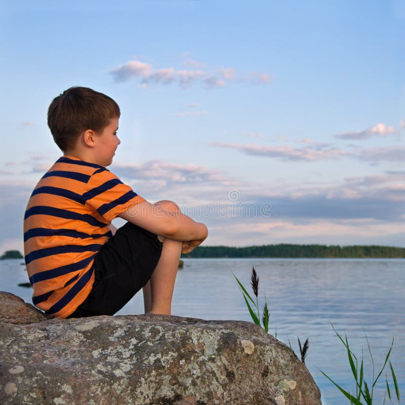 Panorama of a Boy Sitting on Rock in Summer Evening Sunlight Stock ...