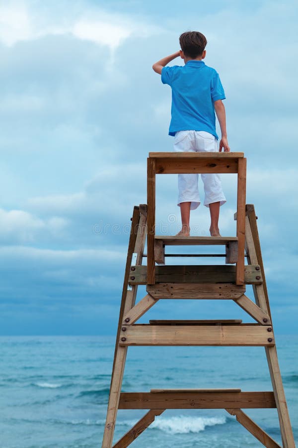 Boy Sitting on Lifeguard Chair Stock Image - Image of mediterranean ...