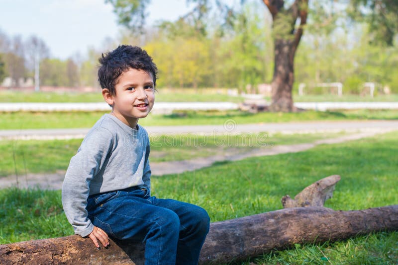 Spring Little Boy Sitting Log Forest Stock Photos - Free & Royalty-Free ...