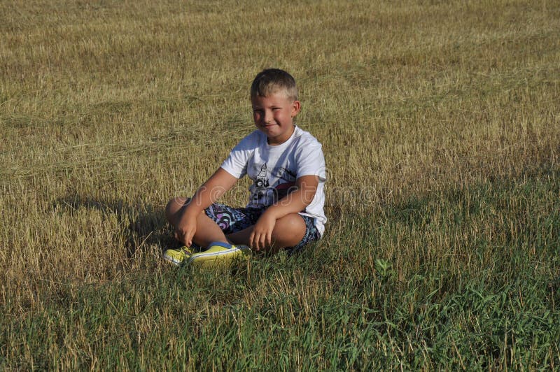 Boy sitting in the meadow stock image. Image of standing - 43710111