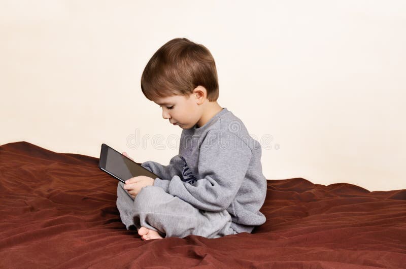 Boy Sitting and Playing on the Tablet Stock Image - Image of curiosity ...