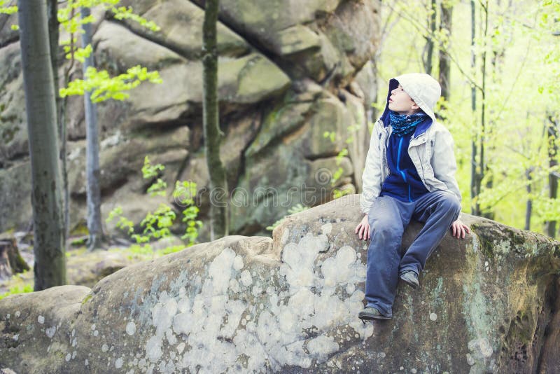Boy sitting on a rock. stock photo. Image of calm, beautiful - 73307166