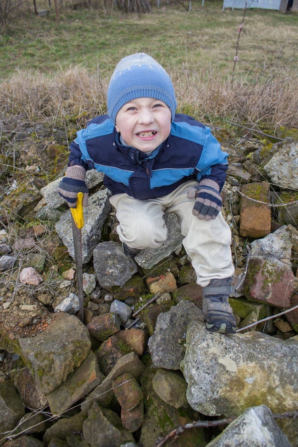 Boy sitting on the rocks stock photo. Image of nature - 87865292