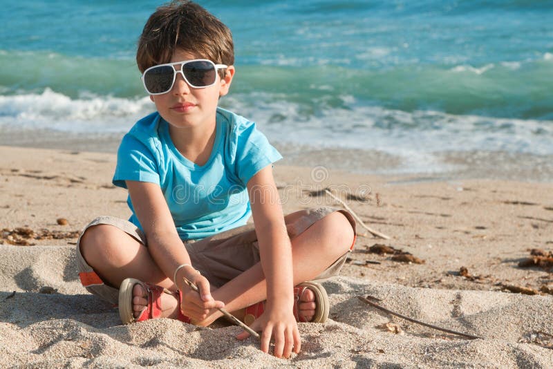 Boy sitting on the sand stock image. Image of young, sand - 26154693
