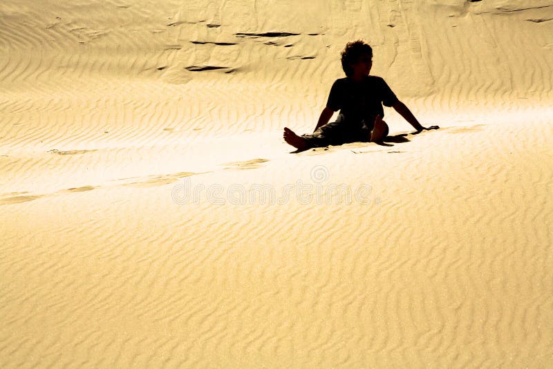 Boy sitting on a sand. stock image. Image of mark, lonely - 200650111