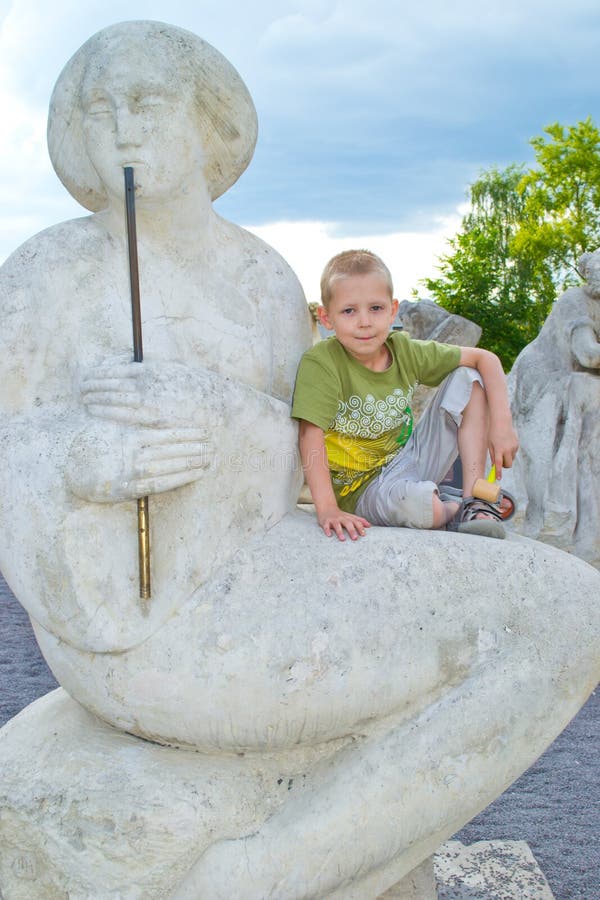 Boy Sitting on a Stone Statue Stock Photo - Image of activity, children ...