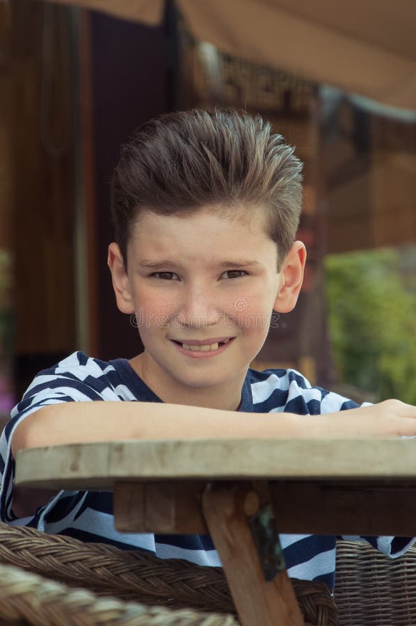Boy Sitting at Table in Cafe Stock Image - Image of casual, male: 105691121