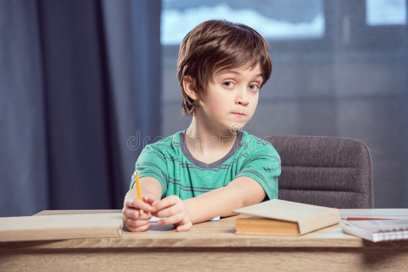 Boy Sitting at Table and Doing Homework at Home Stock Image - Image of ...