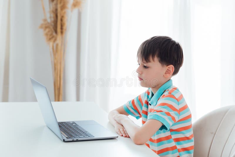 Boy Sitting at Table with Laptop Learning Games Online Stock Image ...