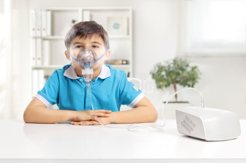 Boy Sitting at a Table and Using a Nebulizer with Mist Stock Image ...