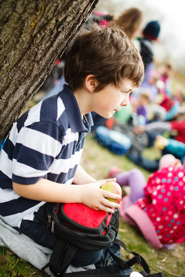 Boy sitting by a tree stock photo. Image of young, male - 30563548