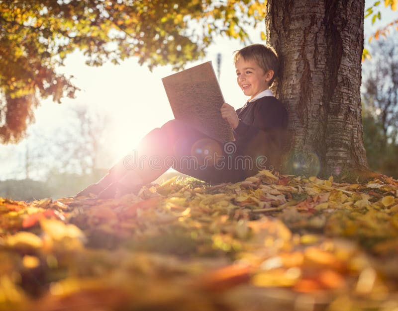 2+ Boy reading book under tree Free Stock Photos - StockFreeImages