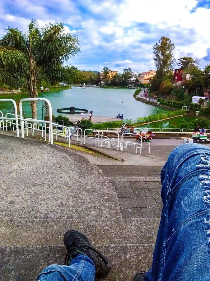 A Boy Sitting Watching a Beautiful Lake. Stock Photo - Image of sitting ...