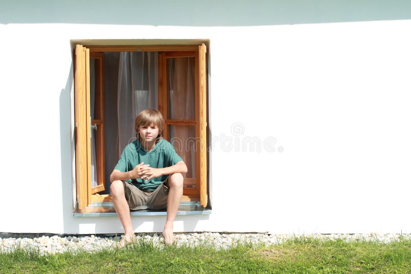 Boy sitting on the window stock image. Image of stones - 25492911