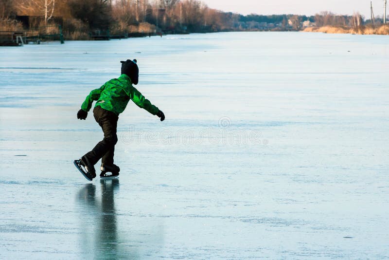 A Boy Skating on the Frozen Lake Stock Image - Image of pants, warm ...