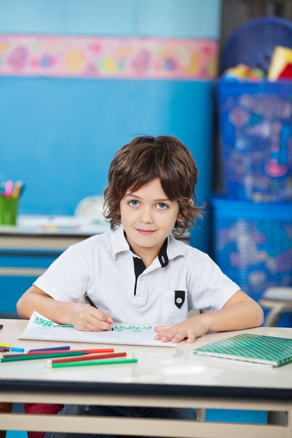 Boy with Sketch Pen Drawing in Classroom Stock Image - Image of casual ...