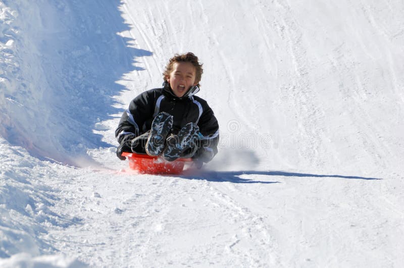 Boy Sledding Down the Hill stock photo. Image of happy - 7637920