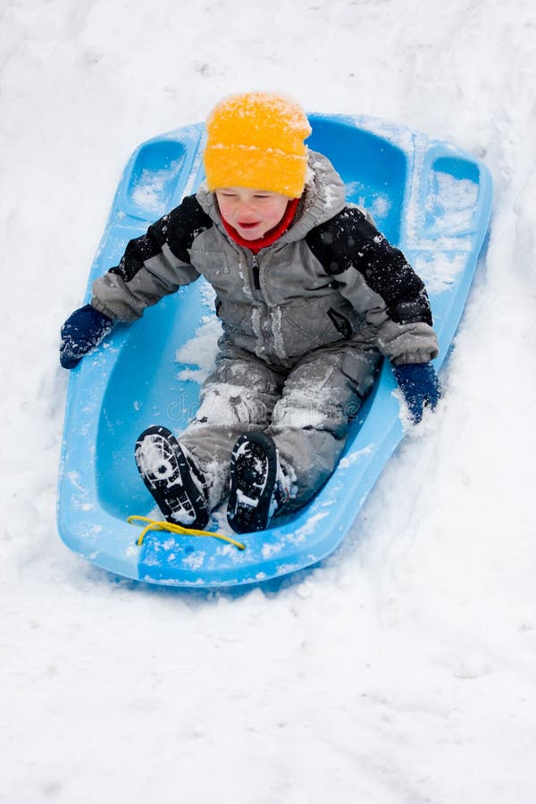 Boy sledding down hill stock image. Image of snow, ride - 8775989