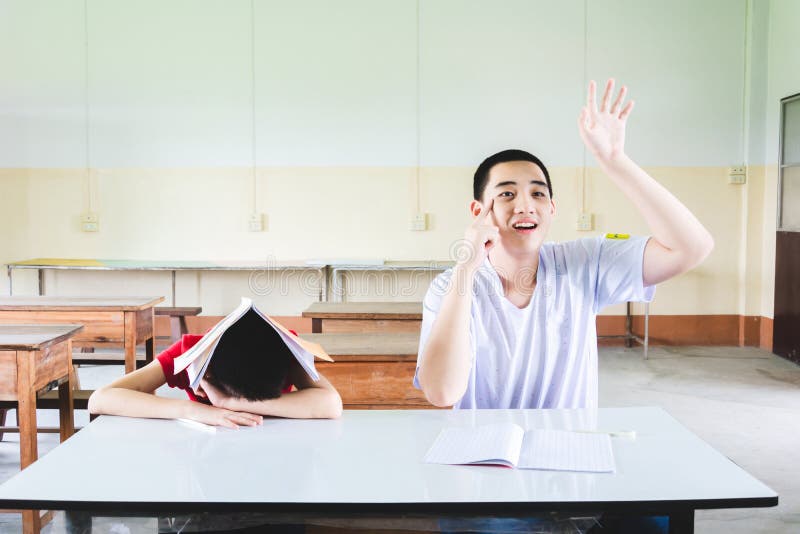 Boy is Sleeping in Class but Another Boy Hand Up To Answer the Question ...