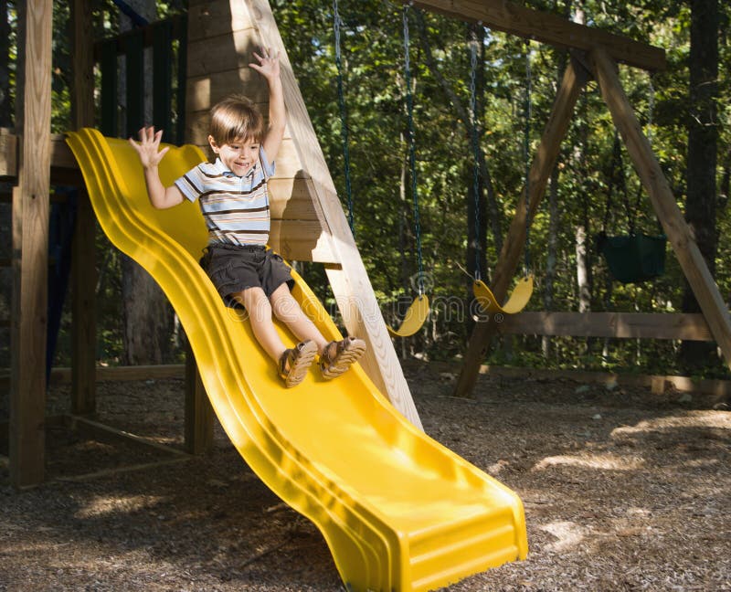 Boy on slide. stock image. Image of park, happy, slide - 4246557