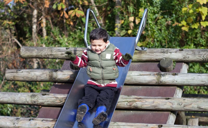 Boy on slide stock image. Image of child, green, smiling - 7518621