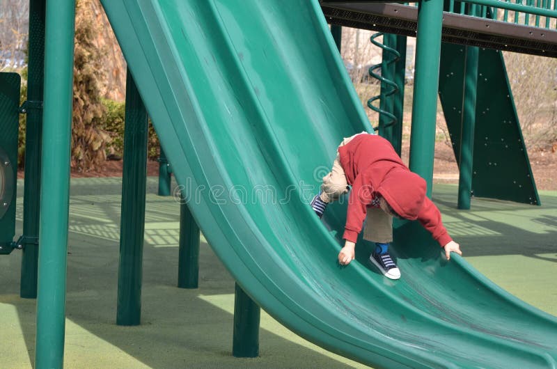 Boy on a slide stock image. Image of playground, green - 42253001