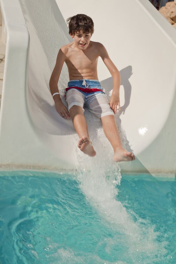 Boy on slide at waterpark stock photo. Image of swim - 44062092
