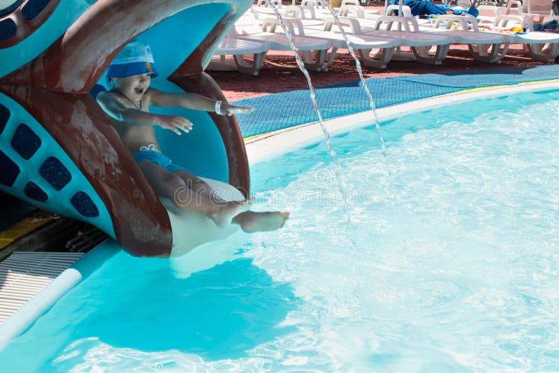 A Boy Slides on a Water Slide into the Pool Stock Image - Image of ...