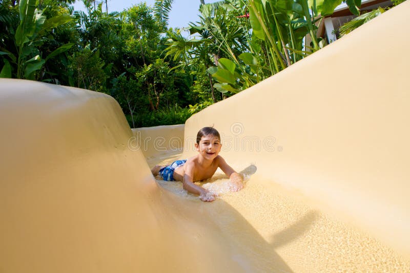 Boy Sliding Down Water Slide. Stock Image - Image of outdoor, speed ...
